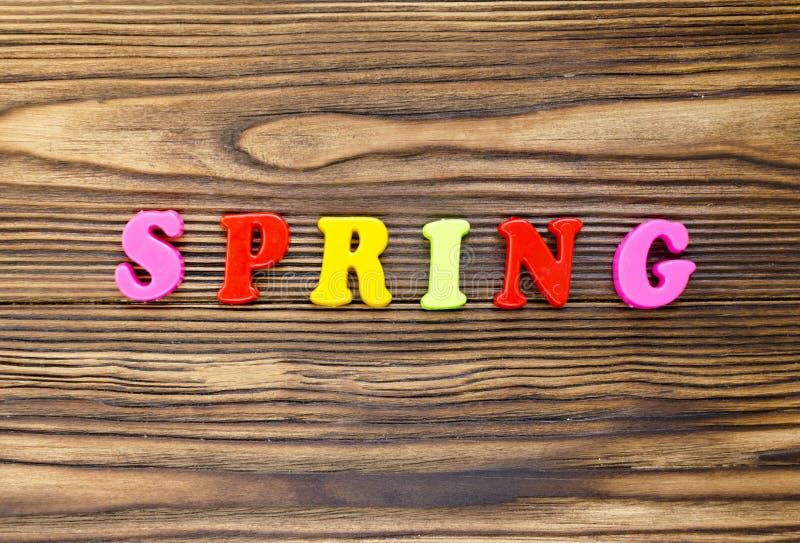 Word `spring` of Plastic Magnetic Letters on Wooden Background. Stock ...