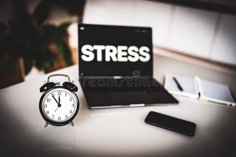Word Stress on the Laptop Screen, Notes and a Clock on a Office Desk ...