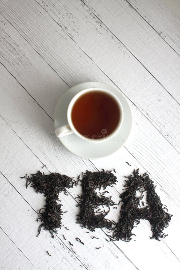 Word TEA Made of Tea Leaves and a Cup of Tea on White Wooden Background ...
