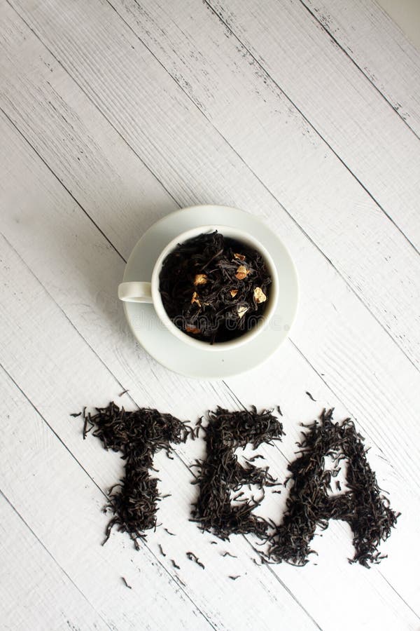 Word TEA Made of Tea Leaves and a Cup of Tea Leaves on White Wooden ...