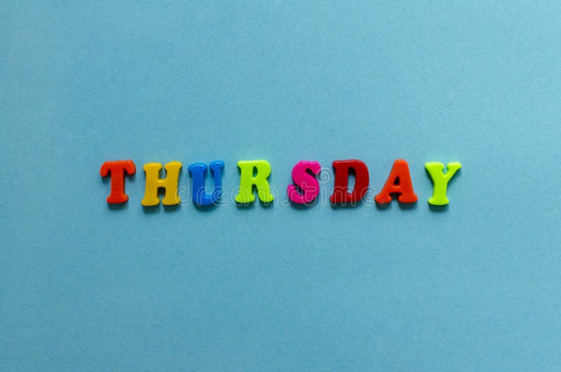 Word `thursday` of Colored Plastic Magnetic Letter on Blue Paper ...