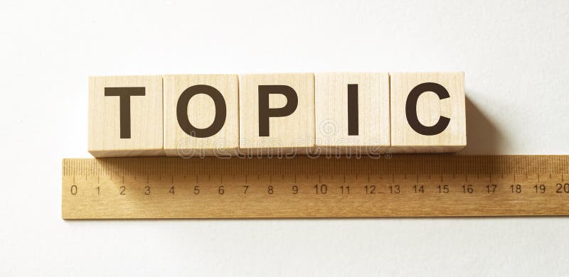 The Word TOPIC is Written on Wooden Cubes. Wooden Cubes on a Green Lawn ...