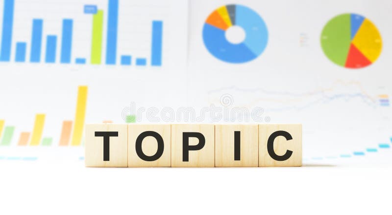 The Word TOPIC is Written on Wooden Cubes. Wooden Cubes on a Green Lawn ...