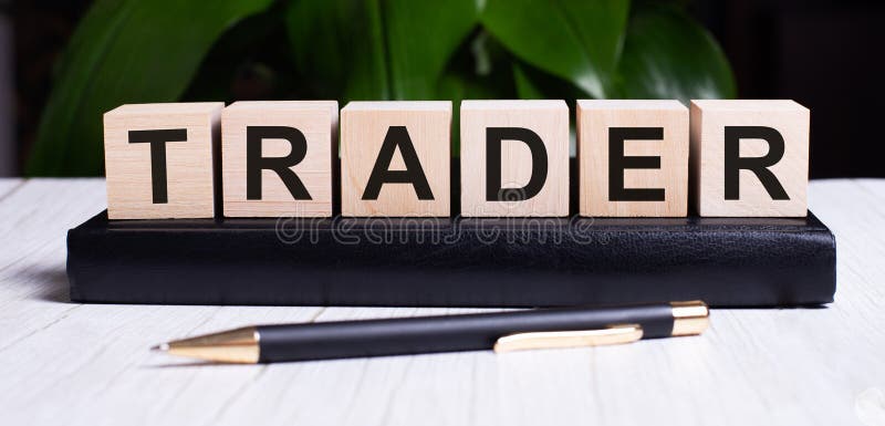 The Word TRADER is Written on the Wooden Cubes of the Diary Near the ...