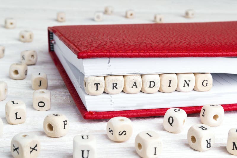 Word Trade Written in Wooden Blocks in Notebook on White Wooden Stock ...