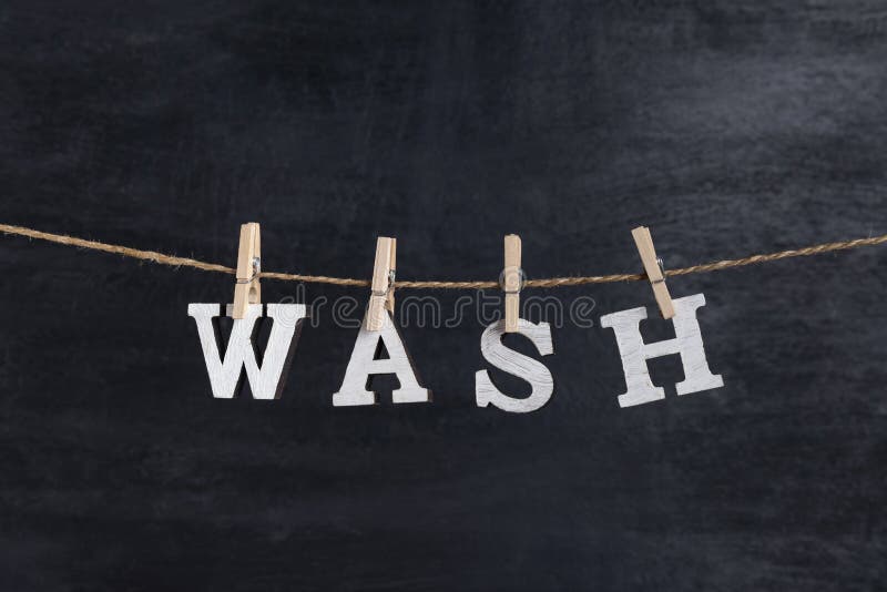 Word WASH with Clothespins on Black Background. Concept of Laundry ...