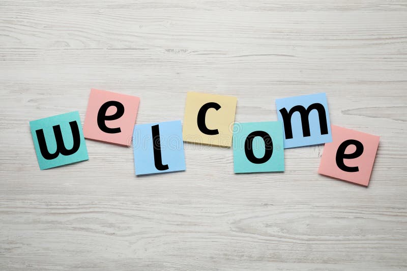 Word Welcome Made of Paper Notes on White Wooden Table, Top View Stock ...