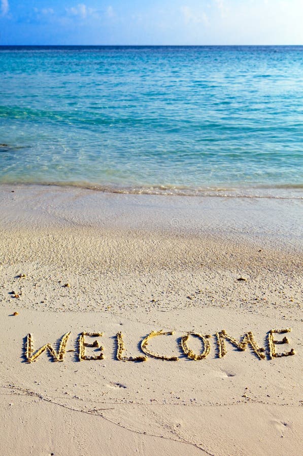 Welcome written on a beach stock photo. Image of beach - 7561638