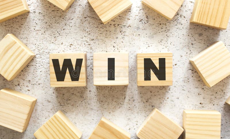 The Word WIN Consists of Wooden Cubes with Letters, Top View on a Light ...