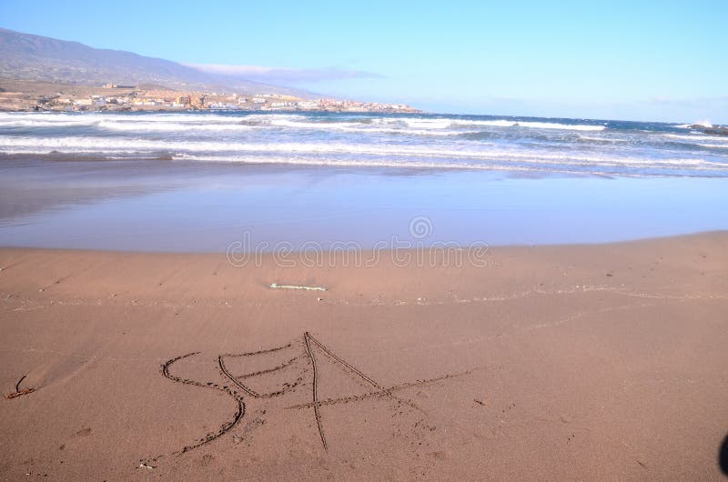 Word Written on the Sand stock image. Image of tropical - 204972939