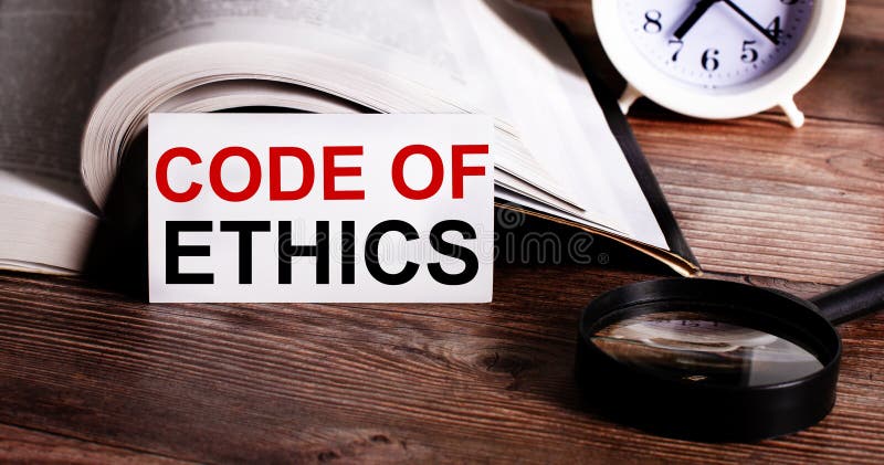 The Words CODE of ETHICS Written on a White Card Near an Open Book ...
