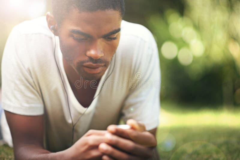 When Words Fail, Music Speaks. a Young Man Listening To Music Outdoors ...