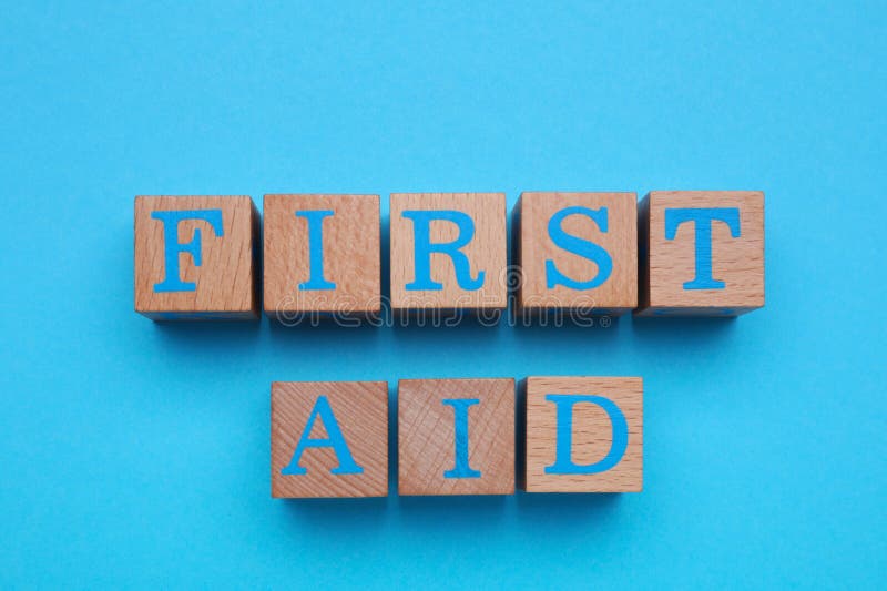 Words First Aid Made of Wooden Cubes on Light Blue Background, Flat Lay ...