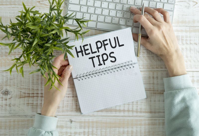 The Words HELPFUL TIPS Written on the Notebook. Notebook in Hand on a ...
