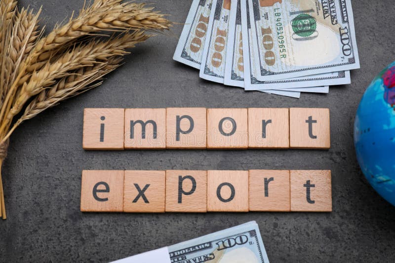 Words Import and Export Made of Wooden Cubes, Ears of Wheat, Banknotes ...