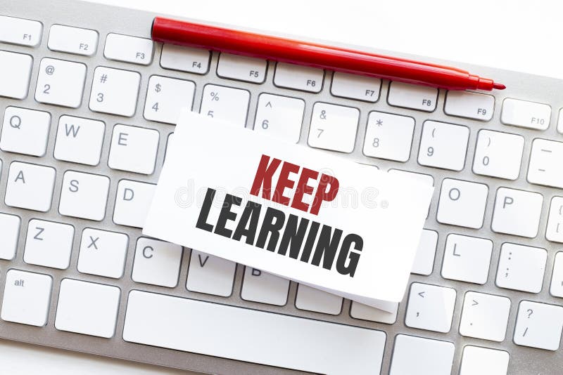 Words KEEP LEARNING Written on Torn Paper on a Computer Keyboard Stock ...