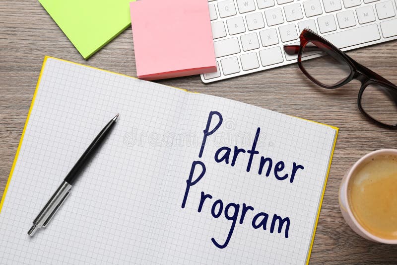 Words Partner Program in Notebook on Office Table. Workplace with ...