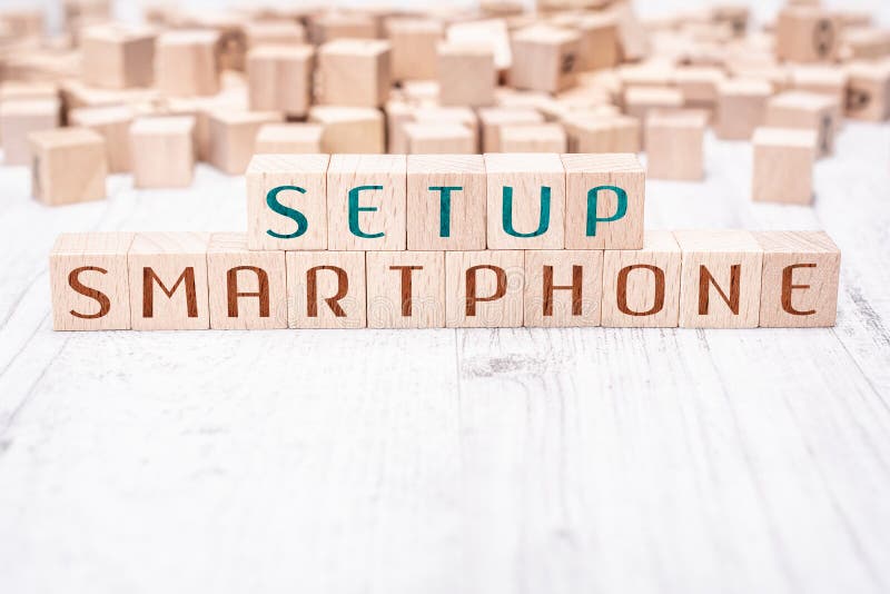 The Words Setup Smartphone Formed by Wooden Blocks on a White Table ...