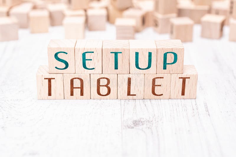 The Words Setup Tablet Formed by Wooden Blocks on a White Table Stock ...
