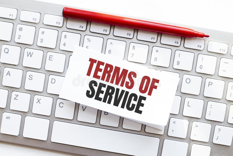Words TERMS of SERVICE Written on Torn Paper on a Computer Keyboard ...
