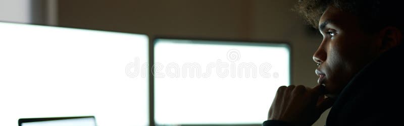 Work All Night. Focused Young Guy Sitting in Dark Room in Front of Many ...
