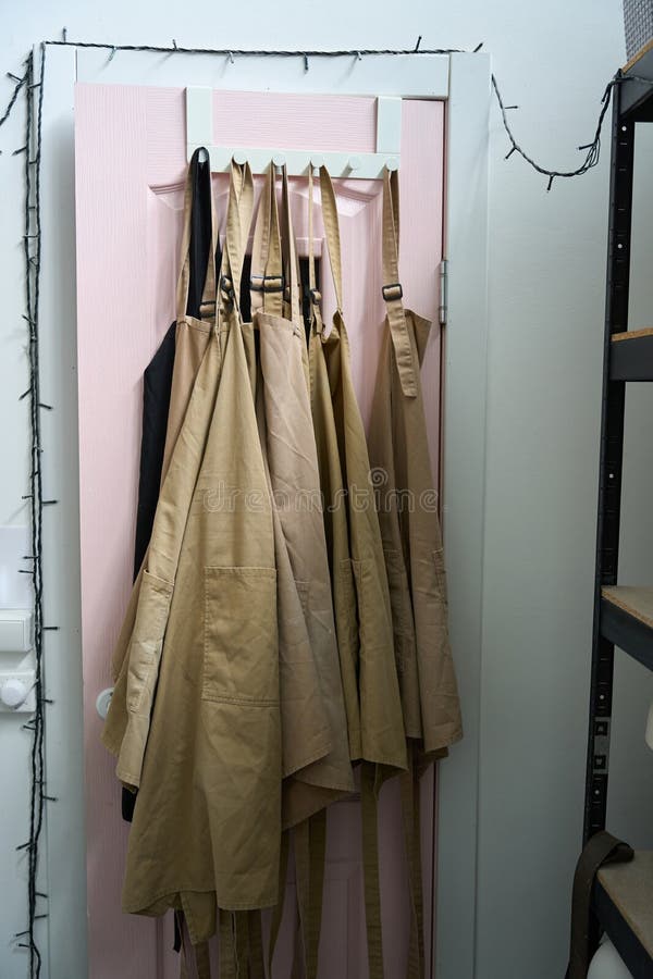 Work Aprons Hang on a Hanger in the Workshop Stock Photo - Image of ...
