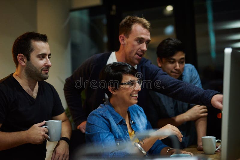 They Work Best As a Team. Employees Working in an Office at Night ...