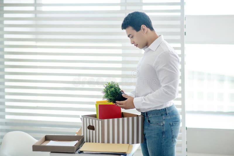 Brunette Male Standing at His Desk, Putting His Personal Stuff into Box ...
