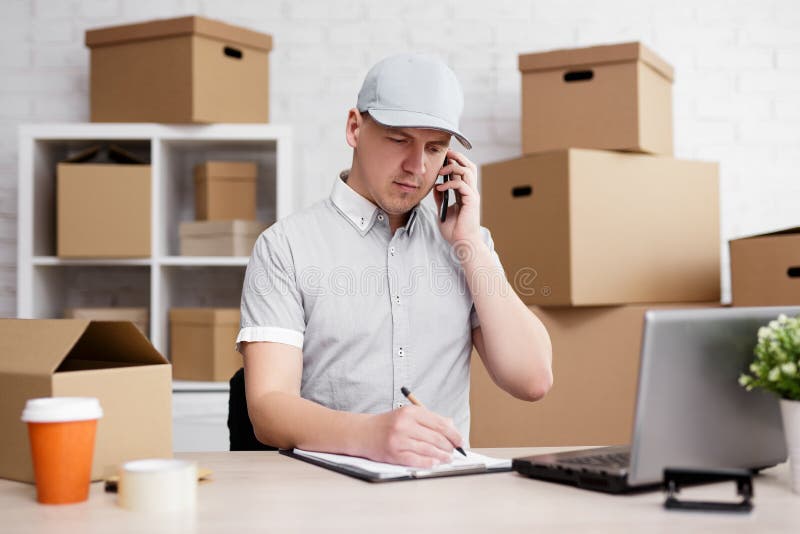 Work and Business Concept - Postman Talking by Phone and Writing ...