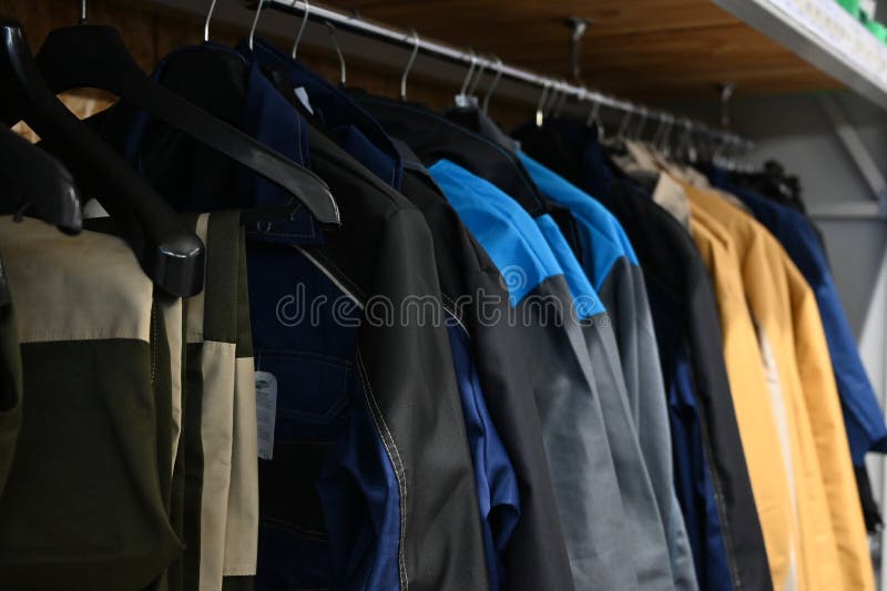 Work Clothes on Hangers in the Store. Jackets Workwear for Builders and ...