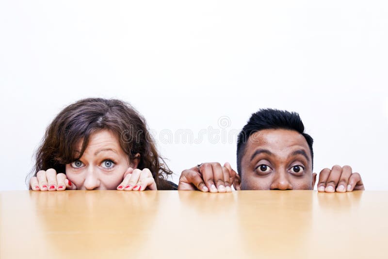 Work Colleagues Peeking Over Edge of Table Stock Image - Image of ...