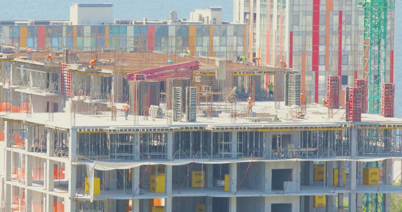 Work at the Construction Site of a Multi-storey Building. Workers Build ...