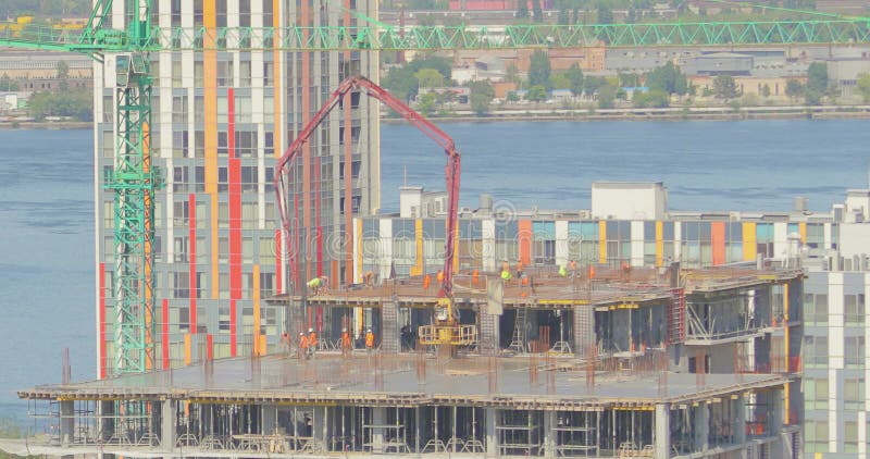Work at the Construction Site of a Multi-storey Building. Workers Build ...