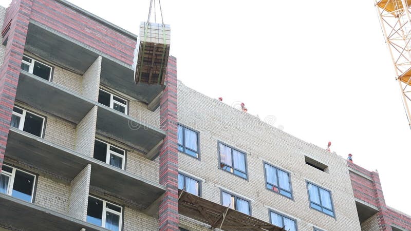 The Work of a Construction Tower Crane in the Summer on a New Building ...