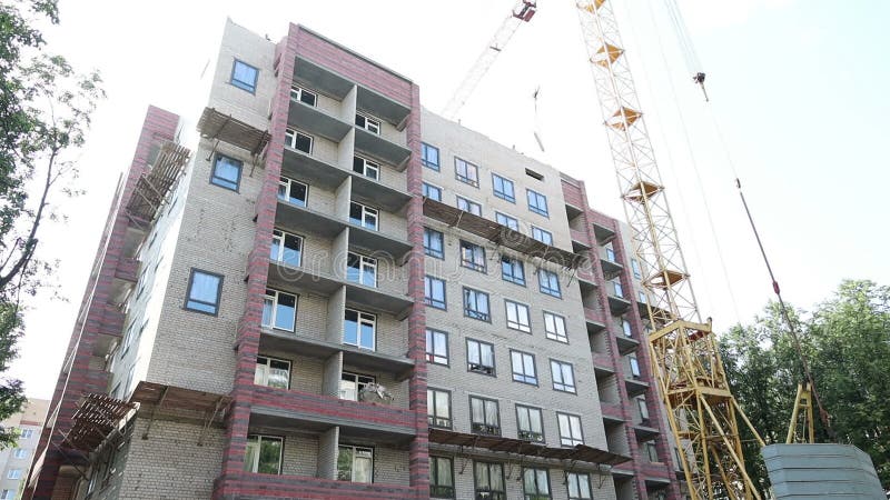 The Work of a Construction Tower Crane in the Summer on a New Building ...