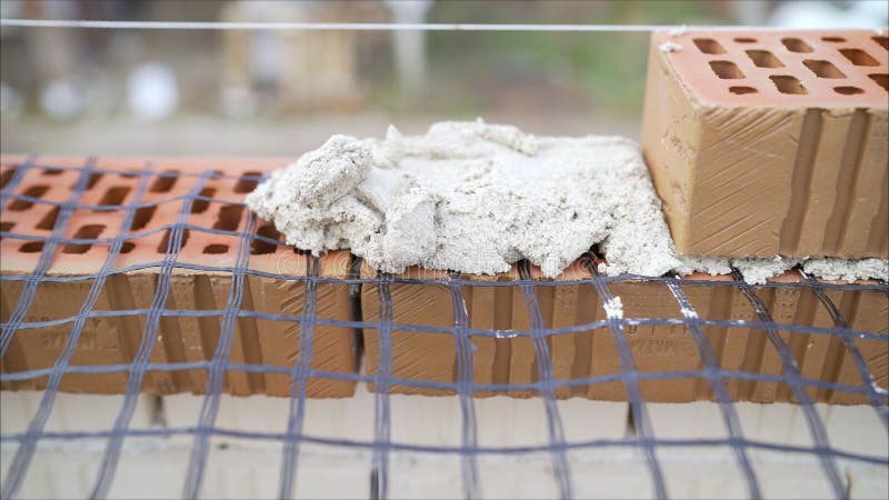 Work with Decorative Stone. Masonry Brick Wall with Mesh Stock Image ...
