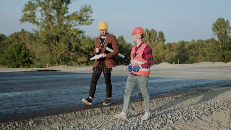 Work Discussion between Builders at Construction Site Outside Stock ...