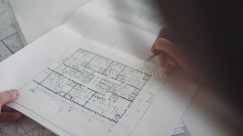 Work with Documents in the Office. Worker Makes Notes in Drawings Stock ...