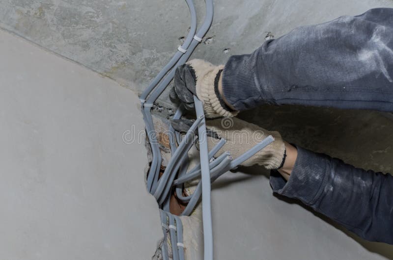 Work Electrician Installs New Wiring in the Wall Stock Photo - Image of ...