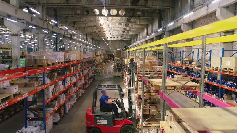 Forklift in a Modern Warehouse. Forklift in the Warehouse Concept. Work ...