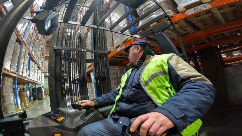 The Work of a Forklift in a Warehouse Pov. Modern Forklift Works in a ...
