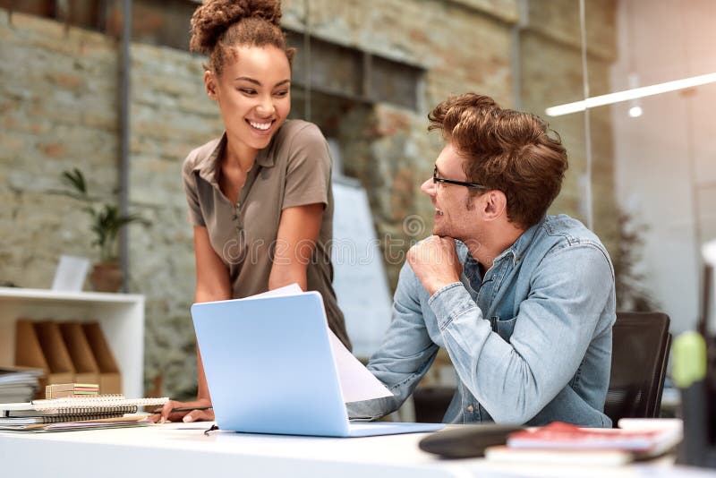 Work Hard Stay Positive. Young Colleagues Looking at Document and ...