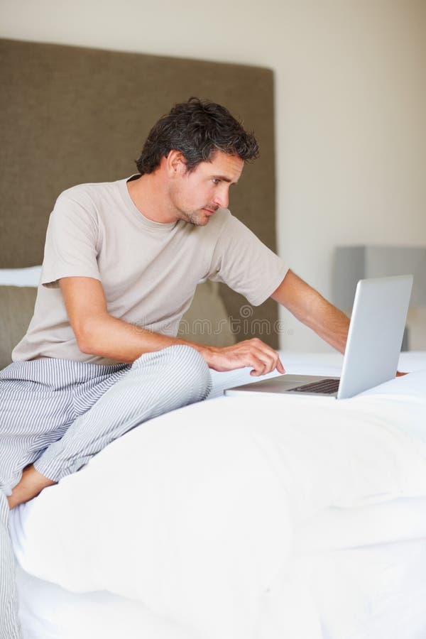 Work from Home. Casually Dressed Mature Man Using Laptop on Bed. Stock ...
