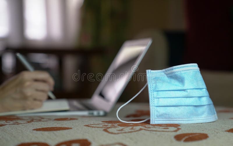 Work at Home during Coronavirus Outbreak. Focus on Face Mask with ...