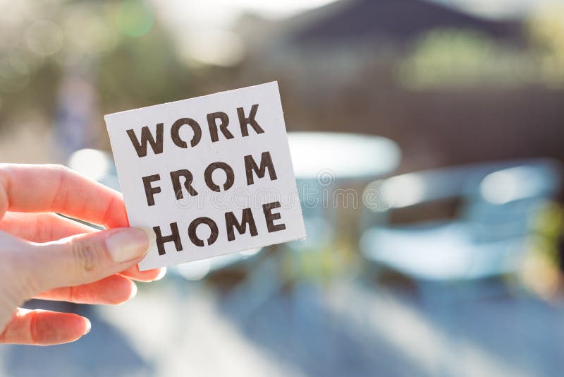 Work from Home Sign Being Hold in Front of Sunny Out of Focus Backard ...
