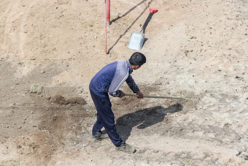 Worker with a rake editorial stock image. Image of preparation - 154022424