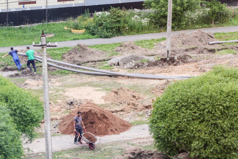 Workers Drag Pipe Along the Trench Editorial Stock Image - Image of ...