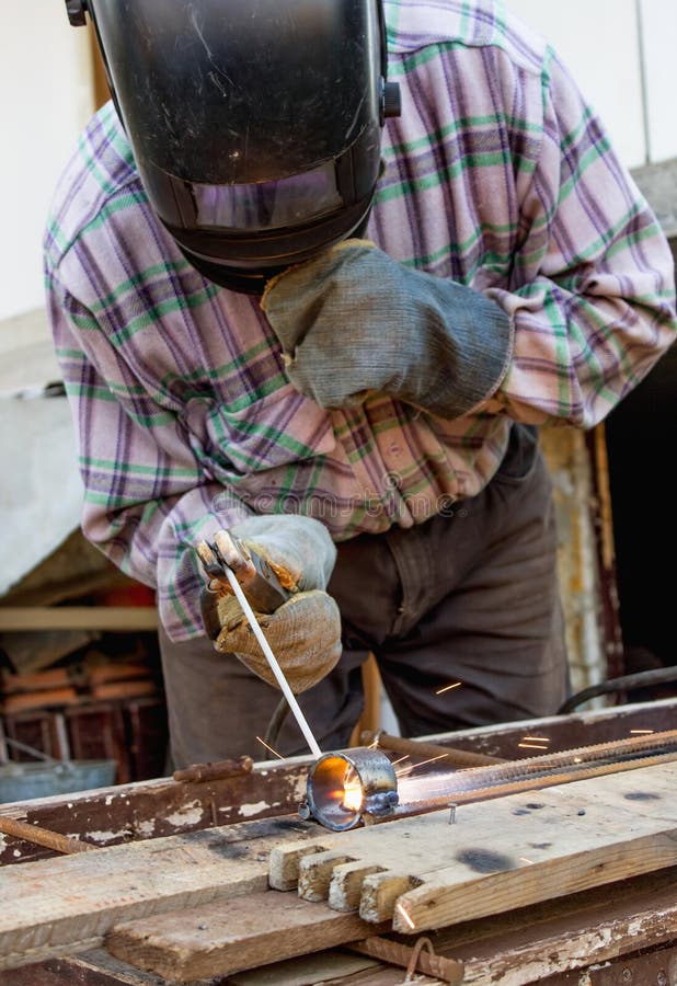 Work in the Industry. a Man Works with a Welding Machine Stock Photo ...