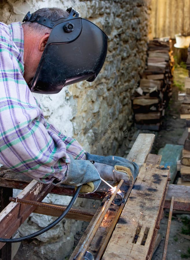 Work in the Industry. a Man Works with a Welding Machine Stock Image ...