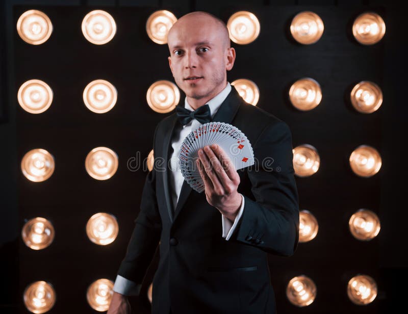 On the Work. Magician in Black Suit Standing in the Room with Special ...